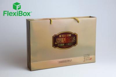 China Champagne Gold Specialty Paper Gift Tote Bag with Red & Gold Hot-Stamped Emblem and Yellow Cord Handles for sale