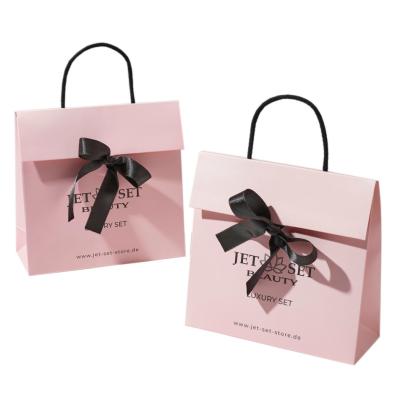 Cina Borsa di spedizione d'imballaggio della carta da stampa del boutique del regalo di acquisto popolare rosa su ordinazione della borsa per l'abito dell'abbigliamento in vendita