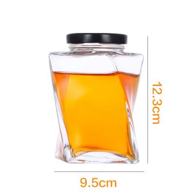 中国 360ml カスタム クリア トイスト 形 ミツバチ ガラス ボトル メタルキャップ付き ユニークな ミツバチボトル 販売のため