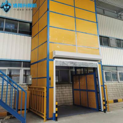 China Customized Yellow Perforated Metal Protection Net Rolling Door Indoor Platform Warehouse Cargo Elevator Steel Heavy Loads Hydraulic Lifts for sale