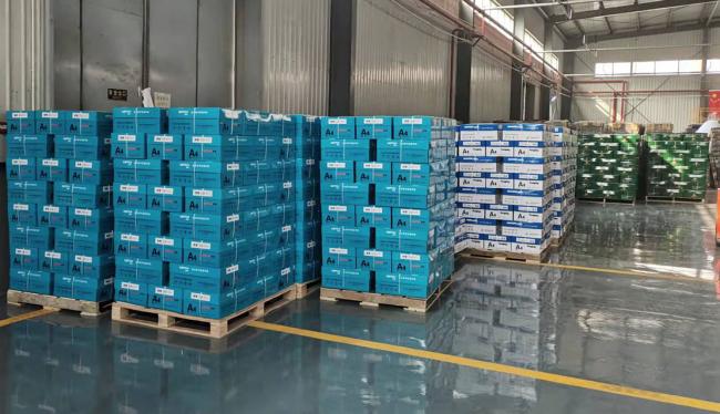 Final packaged A4 paper products stacked for shipping