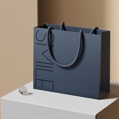 China Custom Logo Kraft Paper Shopping Bag with Rope Handle for sale