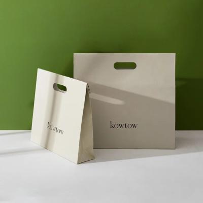 China Die Cut Handle Paper Bag Custom Logo Printing For Fashion Minimalist White Packaging Eco Friendly Material for sale