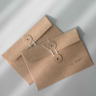 Cina Custom Logo 7*9*3 Kraft Cardboard Mailer Eco Friendly Rope Winding Box Mail Packing Envelop For Phone Case in vendita