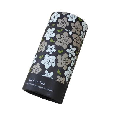 China Eco-friendly matte kraft paper black cylindrical tea packaging, decorated with floral patterns for sale