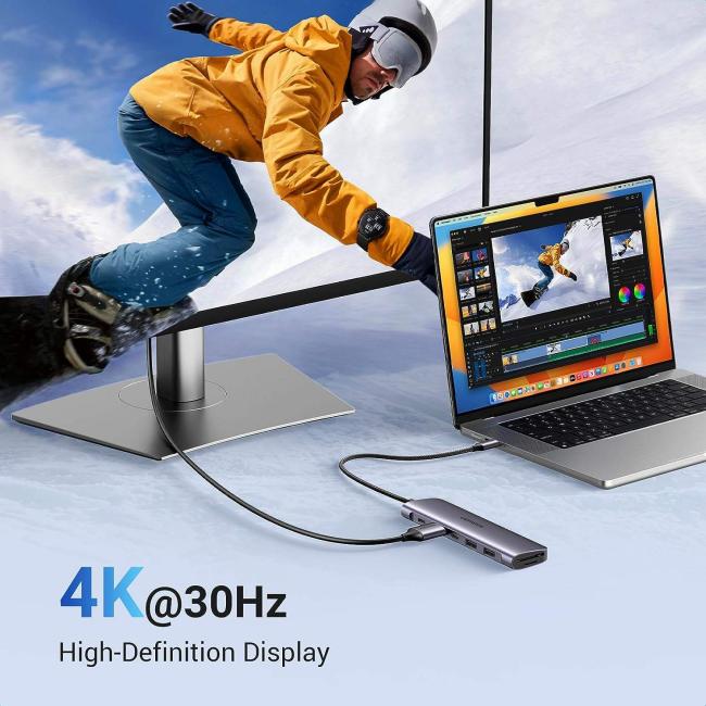 USB C Hub connected to laptop demonstrating simultaneous charging and data transfer