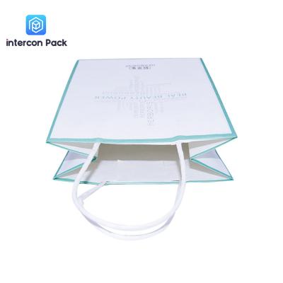 Cina Logo su ordinazione di Kraft del pacchetto del regalo della laminazione lucida bianca dei sacchetti della spesa in vendita