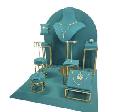 China Luxury Teal Velvet Rose Gold Jewelry Display Stand LED Lit Multi-Height Eco-Friendly Jewelry Showcase for sale