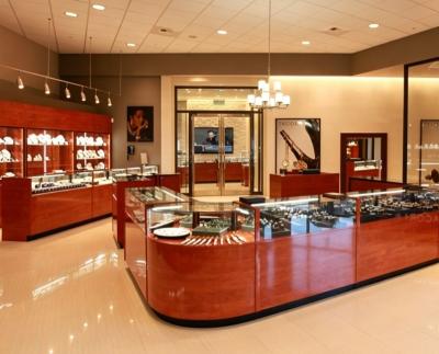 China Classic Red Wood Finish Jewelry Display Cabinet with Curved Central Showcase and Integrated LED Lighting for sale
