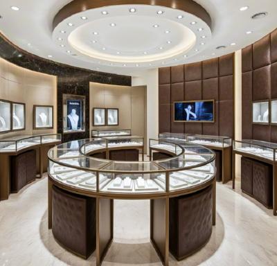 China Custom Bronze Frame Tufted Leather Tempered Glass Jewelry Island Kiosk with Integrated LED Lighting System for sale