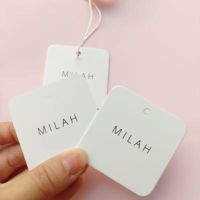 China Wholesale Cloth Tag Gold Foil Printing Tag For Garment Jeans Customized Coated Paper Hangtag For Clothing Own Logo for sale