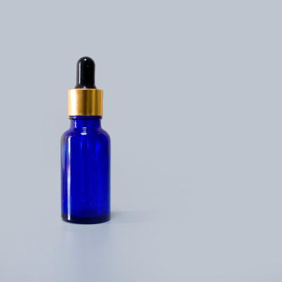 China 20mL blue essential oil glass bottle with child proof dropper plastic rubber cap for sale