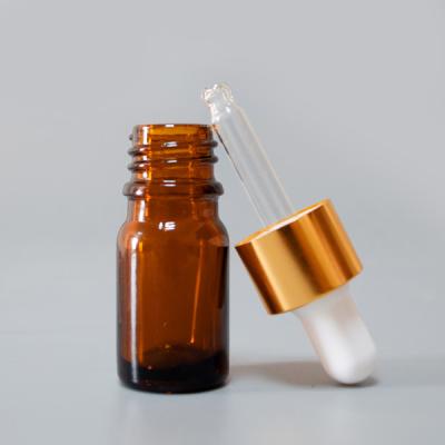 China Hot Selling 10ml 30ml 50ml Glass Essential Oil Bottle with Golden Pipette Dropper for sale