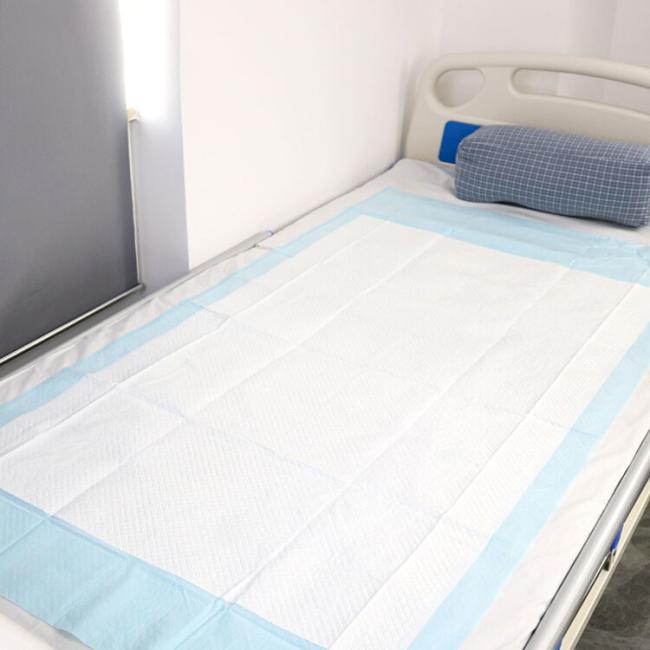 Disposable incontinence bed pads showing multiple sizes and layers