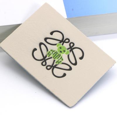 Cina Stampando la toppa di cuoio bianca per il cappello dei jeans copre l'OEM di dimensione di 6.5cm×4.5cm in vendita