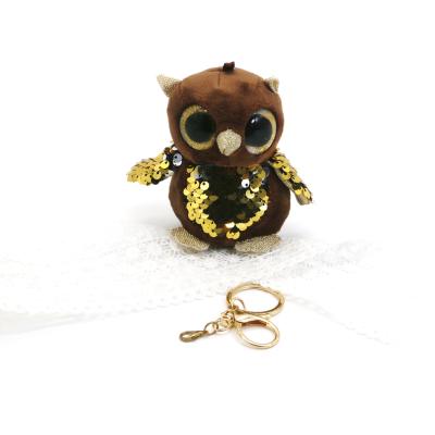 Cina la catena chiave Marrone della bambola della peluche 3D ha ricamato le perle rotonde degli occhi dell'oro intarsiate 10cm del gufo in vendita