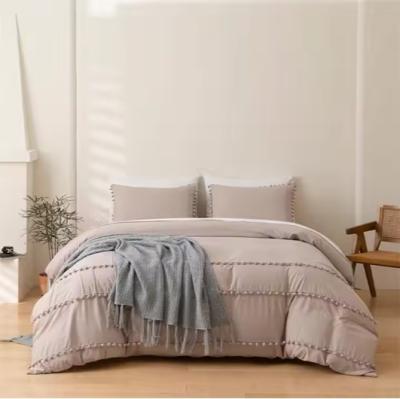 China Luxury Solid Microfiber Comforter Plain Dyed Soft Bedding Comforter Set With Pompom for sale