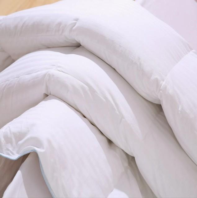 Close-up view of the double stitching and piping on the comforter edge