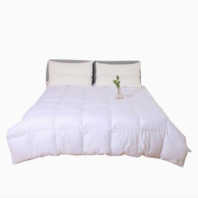 Hotel Quilted Down Comforter displayed on a bed