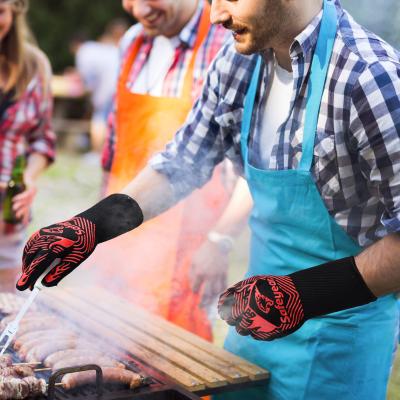 Cina I guanti di funzionamento della sicurezza del silicone del commestibile grigliano il premio termoresistente estremo dei guanti del BARBECUE della griglia dell'aiuto del calore isolati in vendita