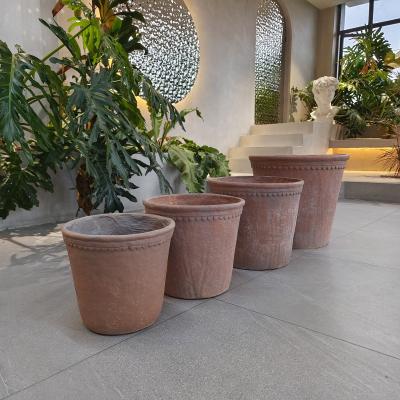 China Durable Fiber Clay Planter With Hand Carved Finish Round Texture Surface for sale
