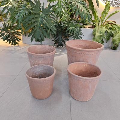 China Durable Fiber Clay Planter With Hand Carved Finish Round Texture Surface for sale