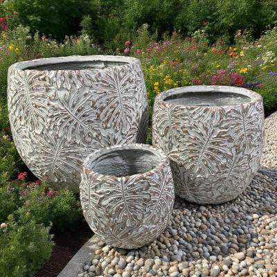 중국 GRC 냄비 회색 둥근 섬유 시멘트 플랜터 몬스테라 잎 디자인 패턴 가벼운 내구성 낮은 유지 보수 꽃 냄비 휴가 빌라 사무실 장식 지붕 정원 조경 프로젝트 판매용