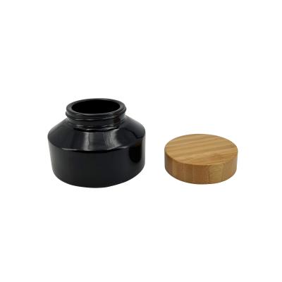 Cina Vaso di crema cosmetica in vetro nero con coperchio di bambù Contenitori di crema per il viso da 30 ml e 50 ml in vendita
