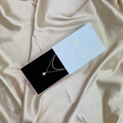China Custom Jewelry Paper Box made from rigid cardboard with matte laminated surface available in flip lid drawer and two piece box styles with hot stamping embossing and UV printing for sale