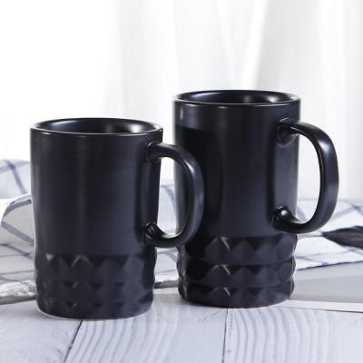 China Wholesale high quality embossed shape golden handle black coffee mug ceramic mug for sale
