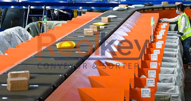 Close-up view of cross belt sorter mechanism showing belt and cart system