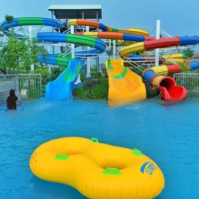 Spiral tube water slide in amusement park setting