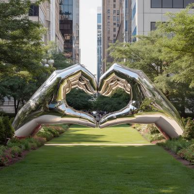 China Custom Love Heart Shape Stainless Steel Hand Sculpture Metal Modern Art Sculptures For Park for sale