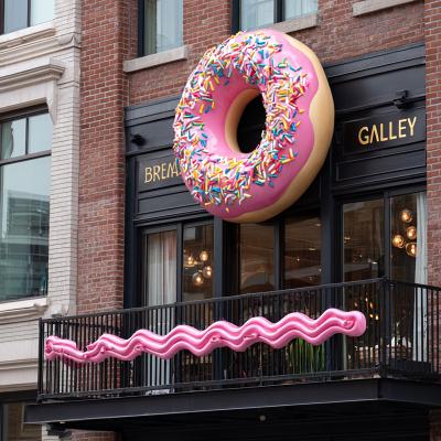 China Life-Size Pink Donut FRP Sculpture For Storefront Eye-Catching Decor for sale