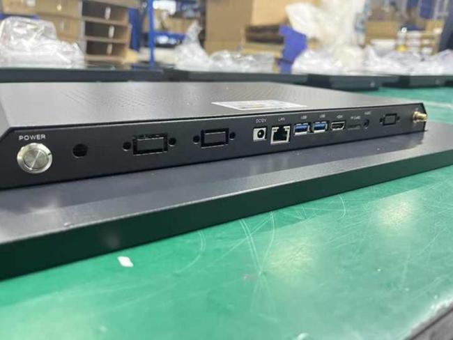 Close-up detail of commercial digital signage interface port strip with USB, HDMI, and LAN connections