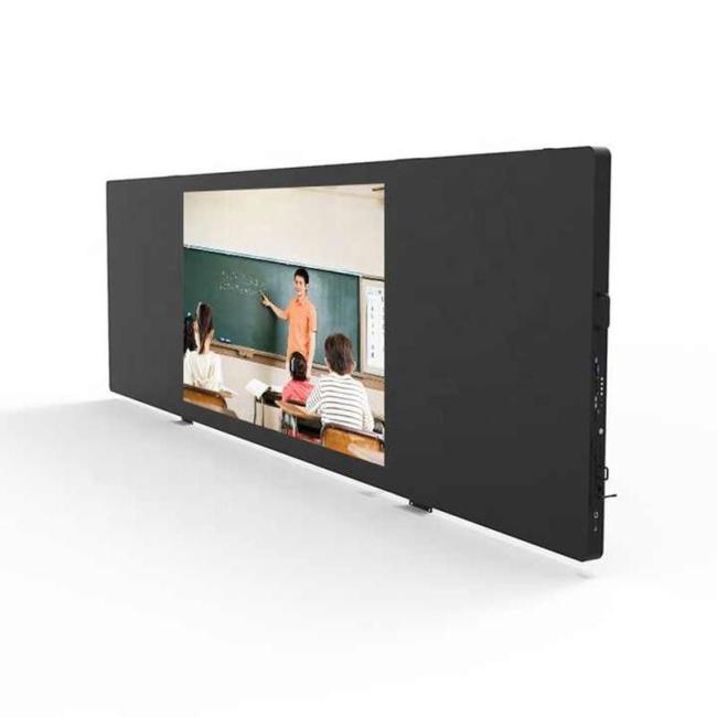 An angled side view of a smart blackboard displaying a teacher inside a classroom setting