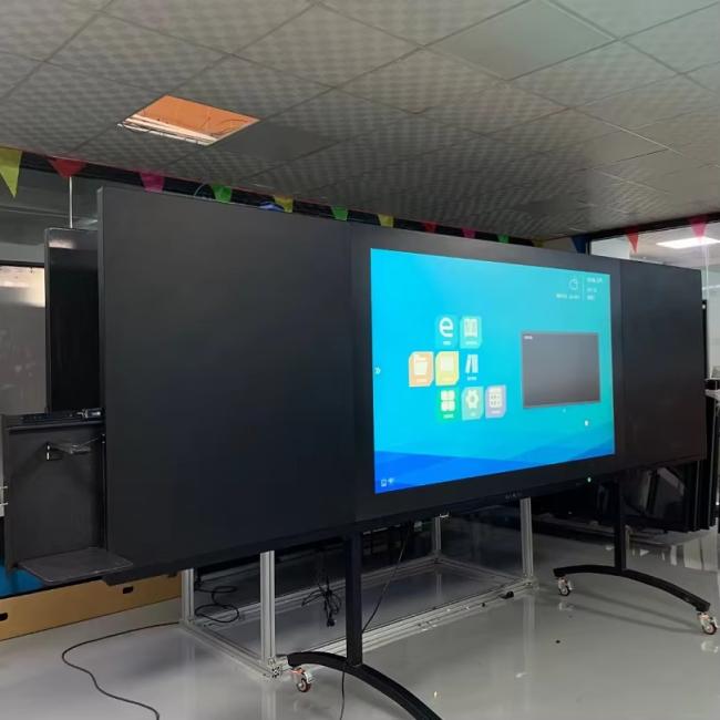 A physical smart blackboard unit mounted on a mobile stand setup inside an office showroom