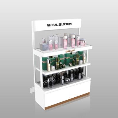 China Beauty Shop Display Stand Platinum Wooden Central Hall Cabinet With Light Box For Cosmetic Retail Display Furniture And Branded Store Design for sale