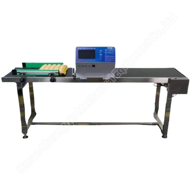 Egg printing machine in operation showing tray of eggs being printed