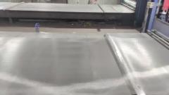 Stainless steel wire mesh is being manufactured and processed in the factory workshop.