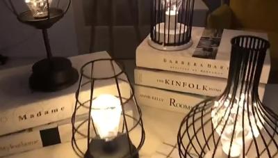 China Retro Wrought Iron Art Hollow Winebottle LED Table Lamp for Bedroom Decoration for sale