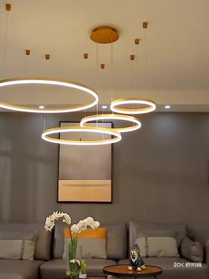China Simple Hanging Decorative Ceiling Pendant Lights Circle Rings Acrylic Gold Luxury Modern Led Chandelier for sale