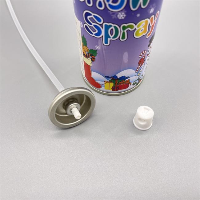 Snow spray valve in use creating artificial snow effect on decorations