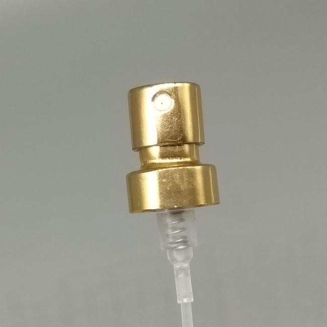 Silver finish perfume pump installed on fragrance bottle