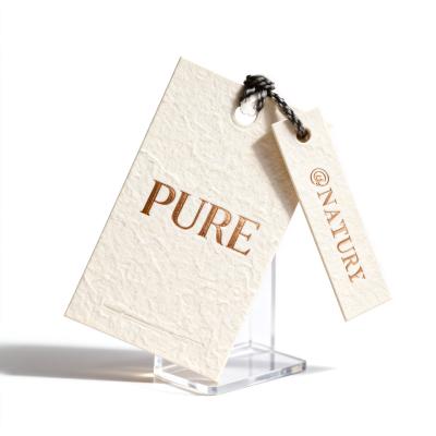 China Made from double-sided art paper and 3mm cotton cord, these garment tags are ideal for use in garment bags and suitcases, and feature a digitally printed brand logo. for sale