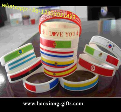 China Custom embossed/imprinted/printed logo Silicone Wristband/bracelet with flag for sale
