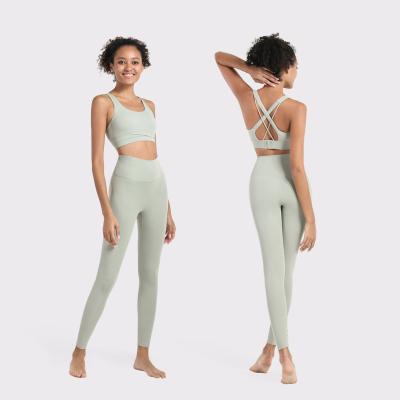Cina Set da yoga in 2 pezzi da donna tinta unita Sexy reggiseno incrociato sul retro Abbigliamento sportivo Leggings da yoga in vendita