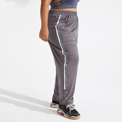 Cina Le donne più i pantaloni di yoga di dimensione allentano le ghette atletiche di allenamento dei piedi casuali di legatura in vendita