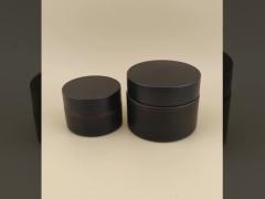 Vaso di crema in vetro nero dal design accattivante con coperchio a vite per lozione