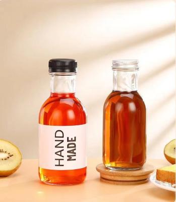 Cina 300 g Bottella di vetro per bevande personalizzata per imballaggi ecologici in vendita